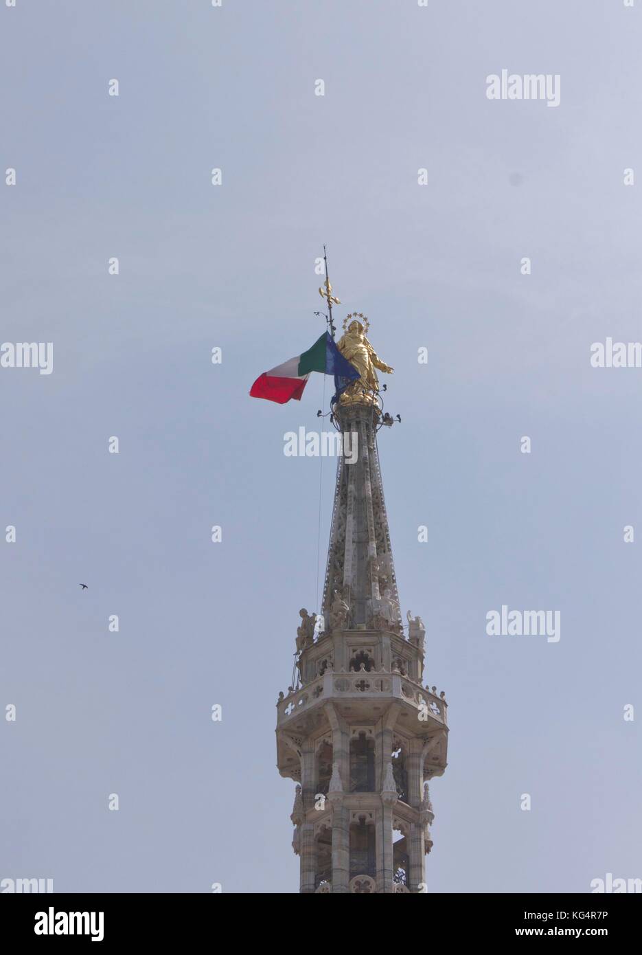 MILANO, ITALY - MAY 9: Gold statue of virgin mary, on the top of Milan ...