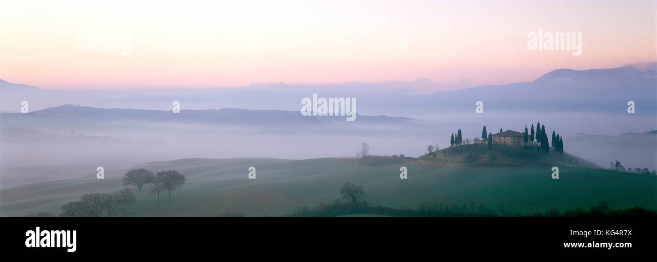 Italy. Tuscany. Early morning mist over panoramic landscape Stock Photo ...