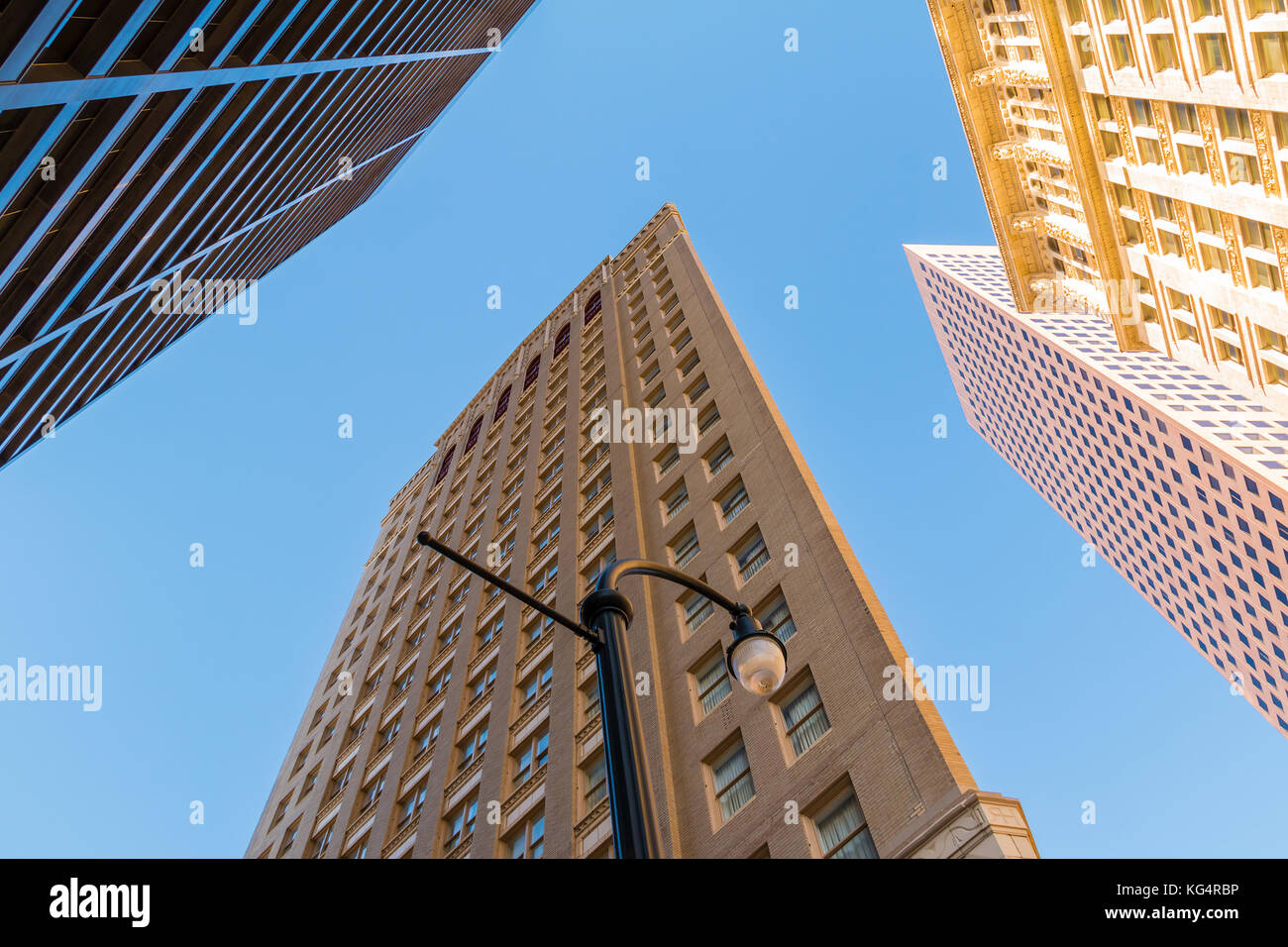Bottom view of streetlight and skyscrapers on the background of clear ...