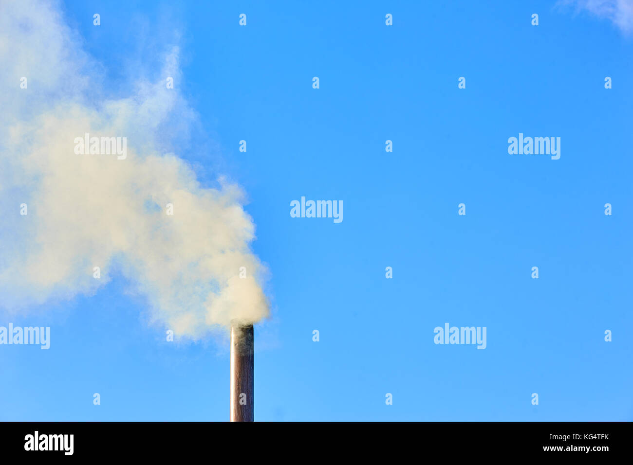 Smoke comes from the chimney of the house. The pipe on the roof ...