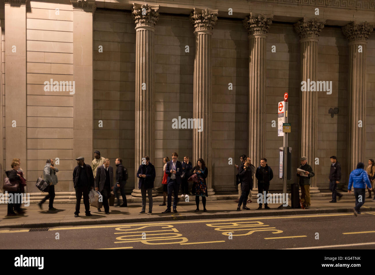 Rush-hour commuters wait for buses in Threadneedle Street, beneath the ...