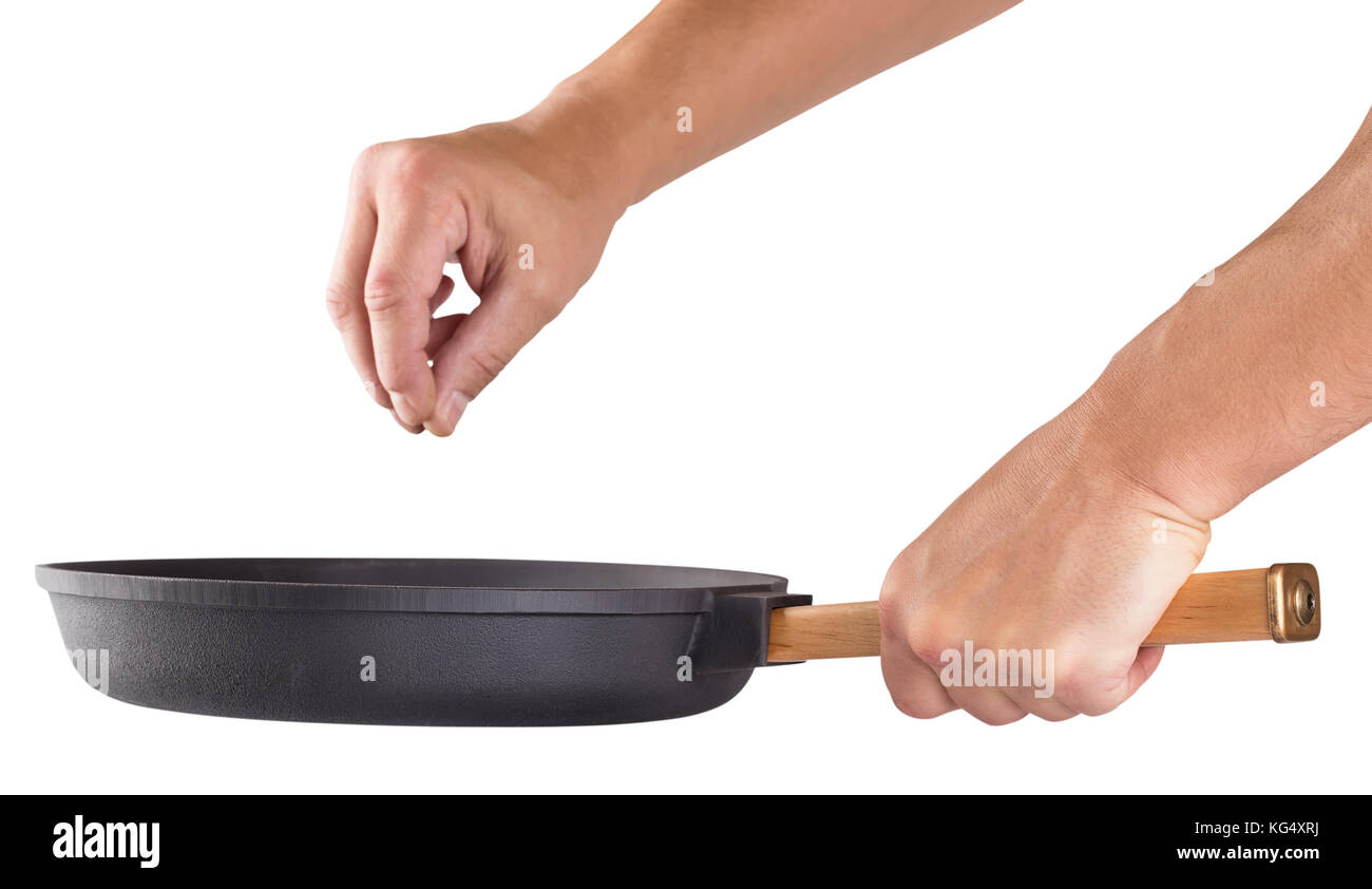 Male hands prepare food in a frying pan isolated on a white background ...