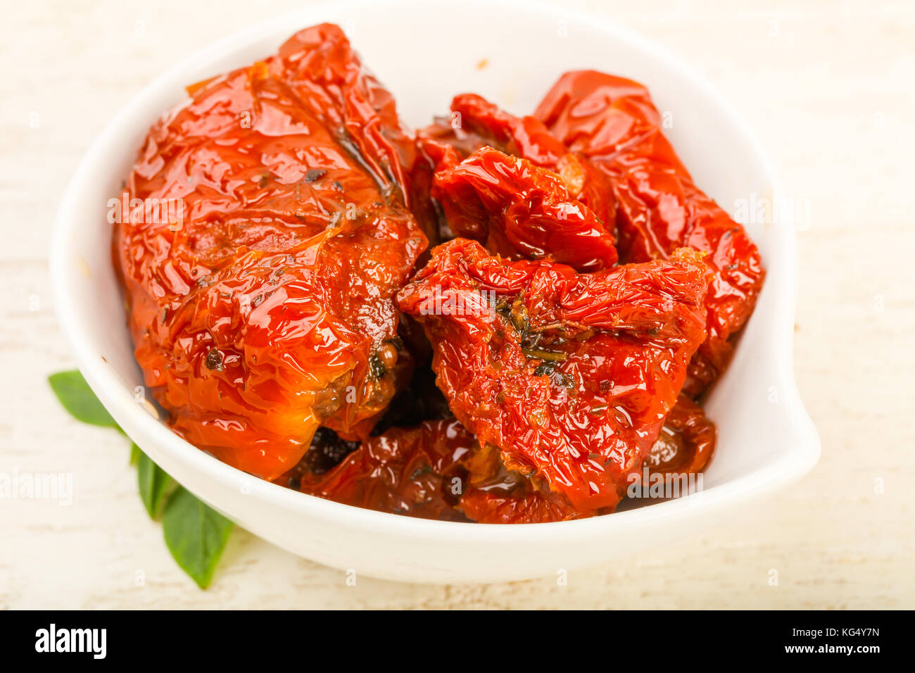 Dried tomato in olive oil with basil leaves Stock Photo - Alamy