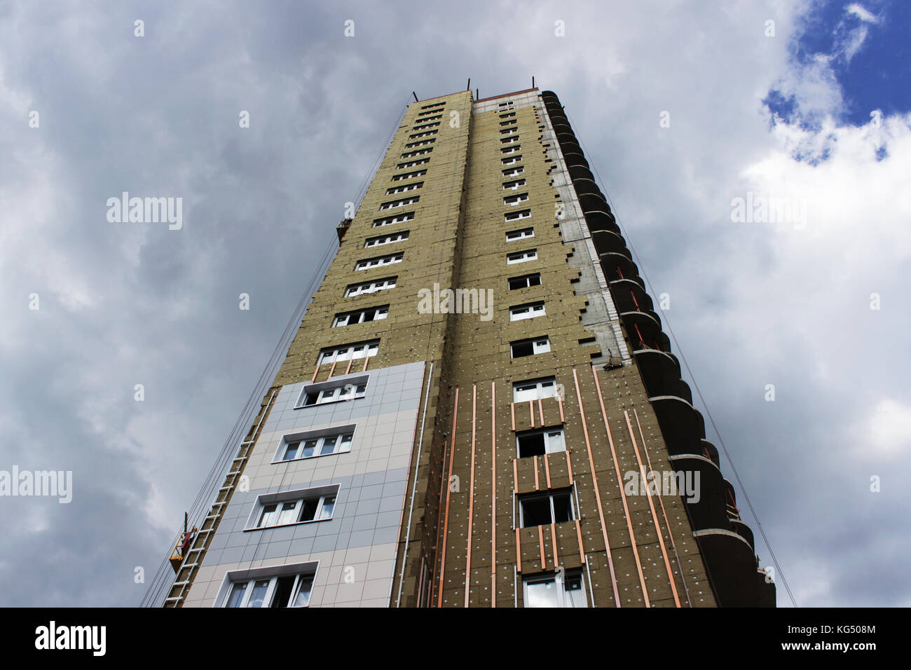 newly built high-rise building with insulating ecological modern panels ...