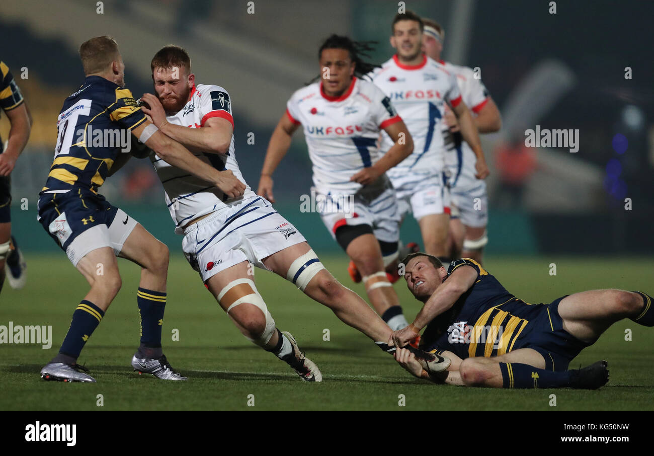 Sale's Sam Moore is tackled by Worcester's Michael Dowsett and Max ...
