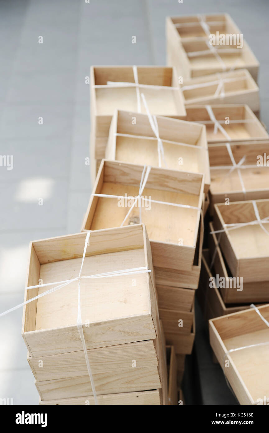 Square wooden boxes, connected by a rope Stock Photo - Alamy