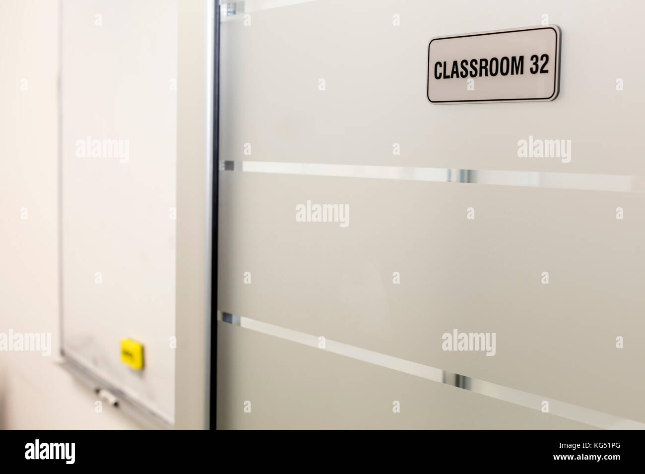 Modern classroom glass doors with number plate; whiteboard in the ...