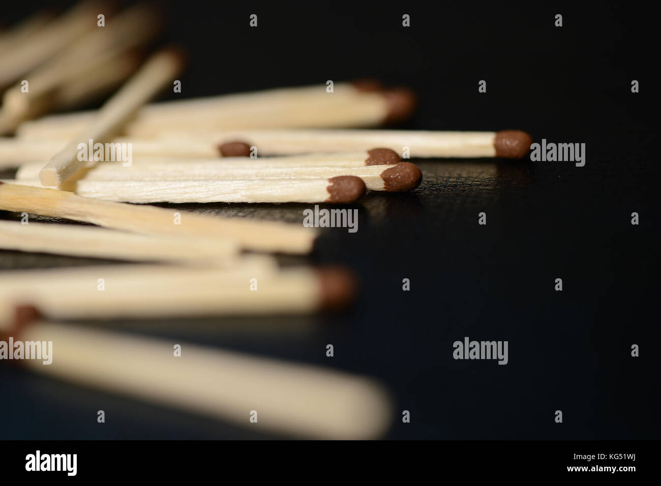 Scattered matches on dark background close up Stock Photo - Alamy