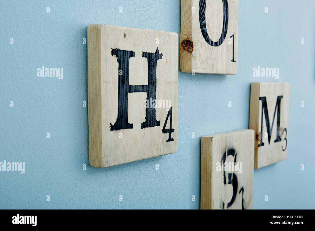 do it yourself large scrabble letters on blue wall Stock Photo - Alamy