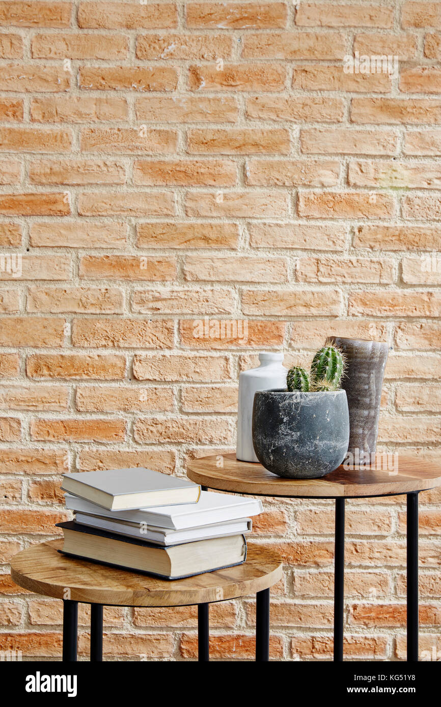 side tables decorated in front of red brick wall Stock Photo - Alamy