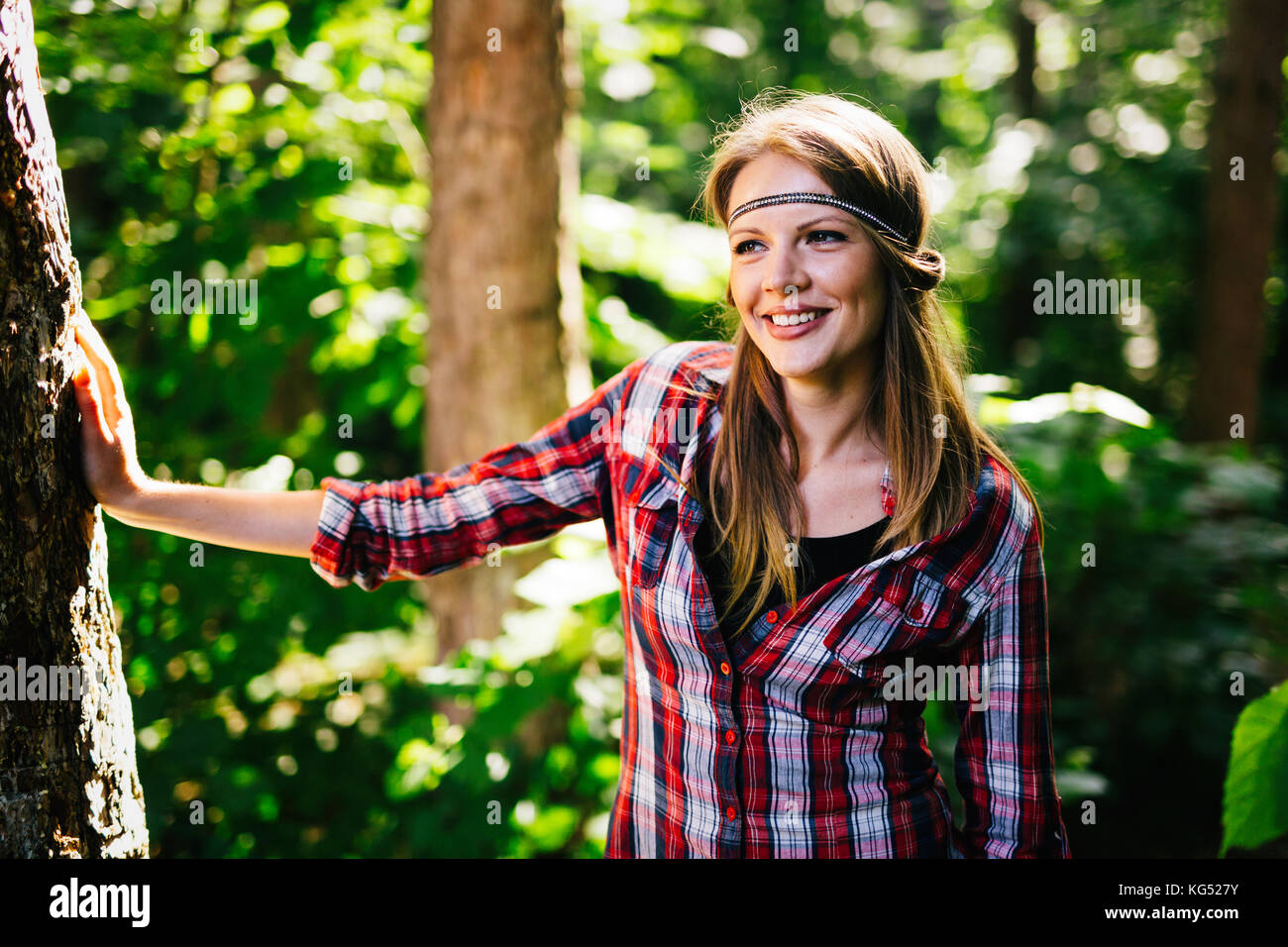 Beautiful woman smiling in forest Stock Photo - Alamy