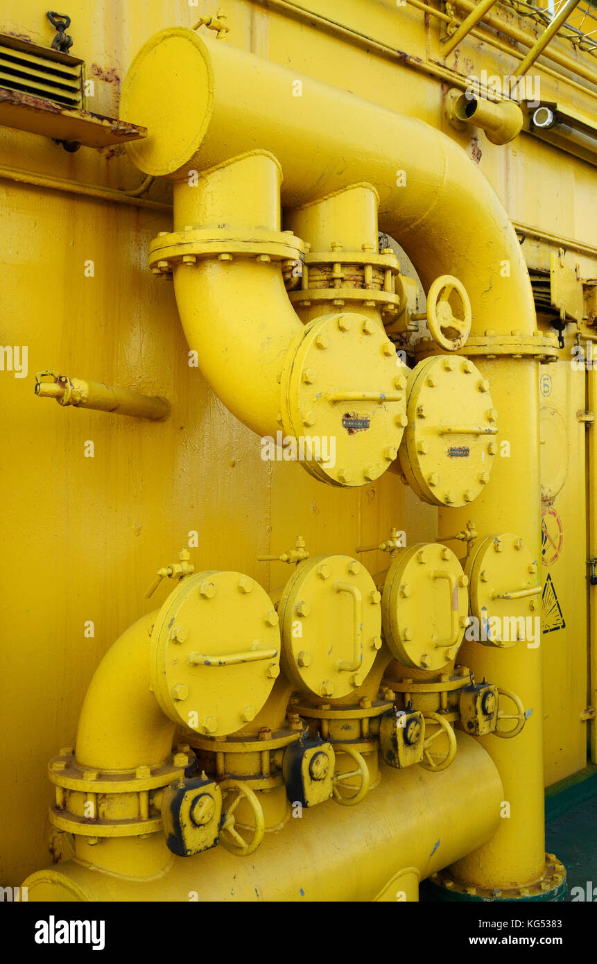 Metal pipes on the ship,painted in yellow color Stock Photo - Alamy
