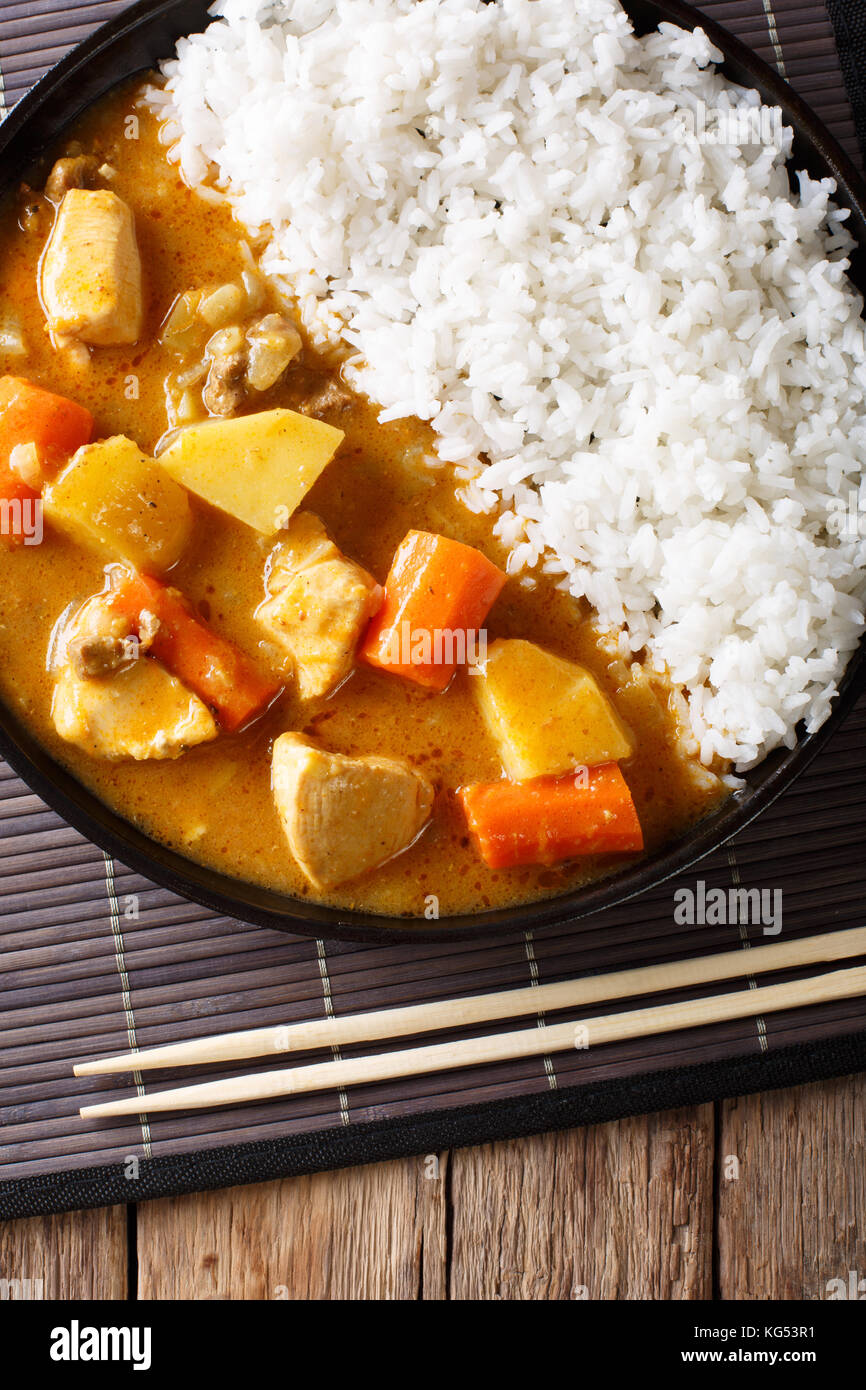 Japanese curry with rice (Kare Raisu) close-up on a plate. Vertical top ...