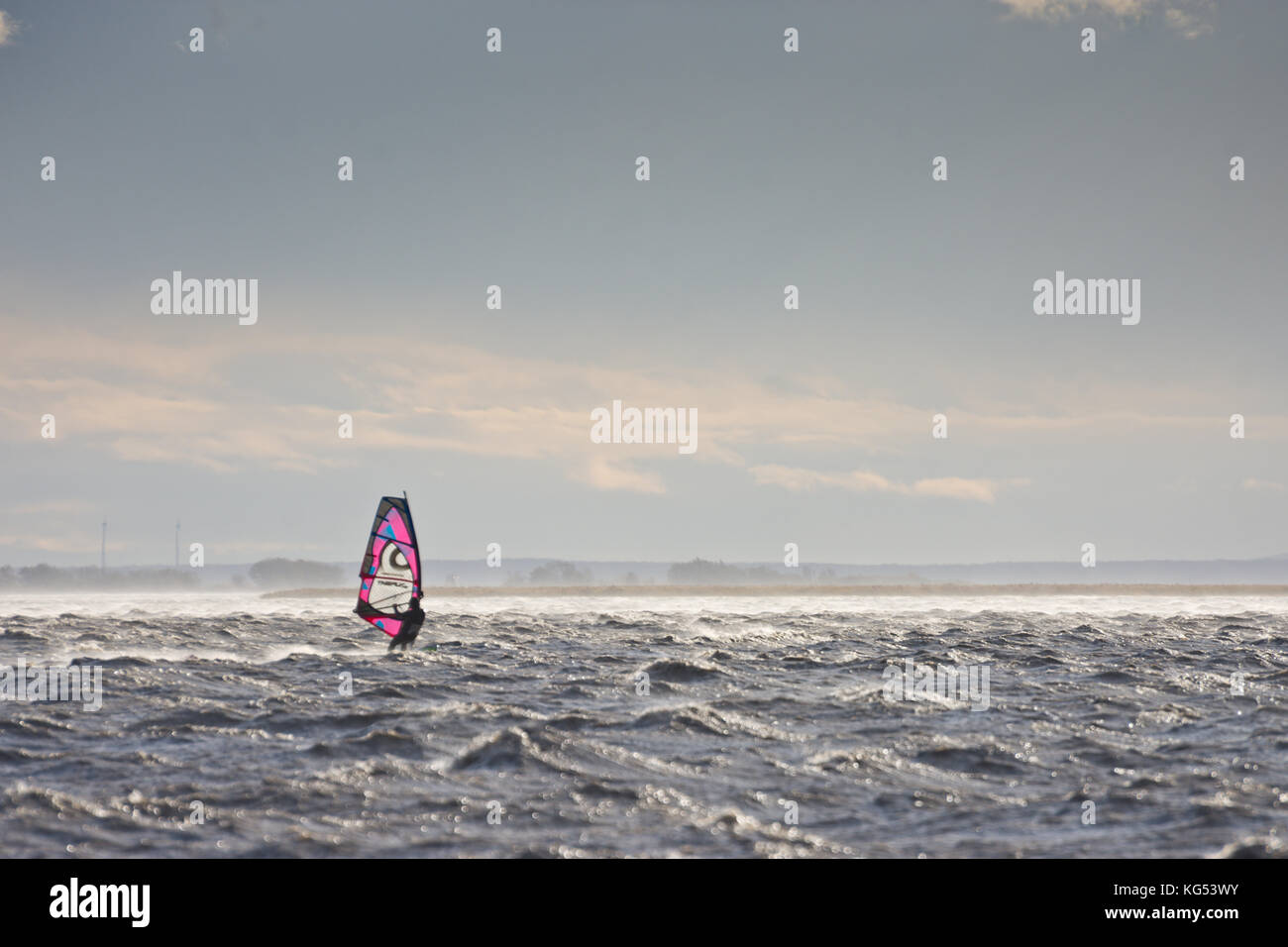 Windsurfer in a storm surfing up to the horizon Stock Photo - Alamy