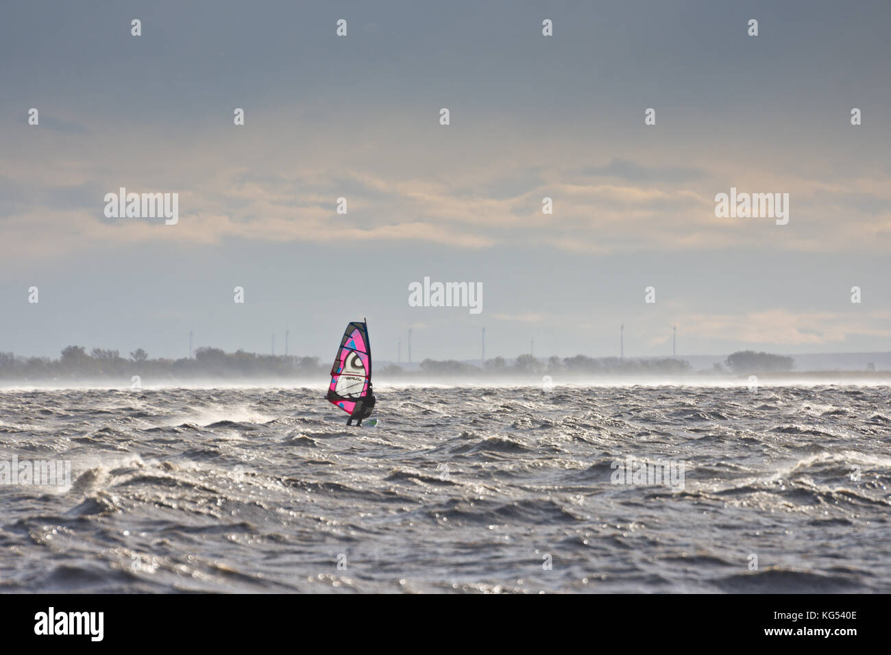 Windsurfer in a storm surfing up to the horizon Stock Photo - Alamy