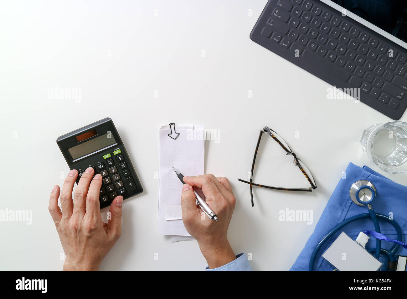 top view of Healthcare costs and fees concept.Hand of smart doctor used ...