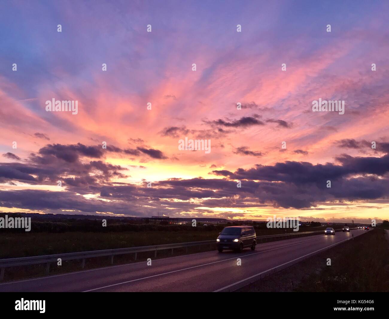 Cars driving during dramatic sunset Stock Photo - Alamy
