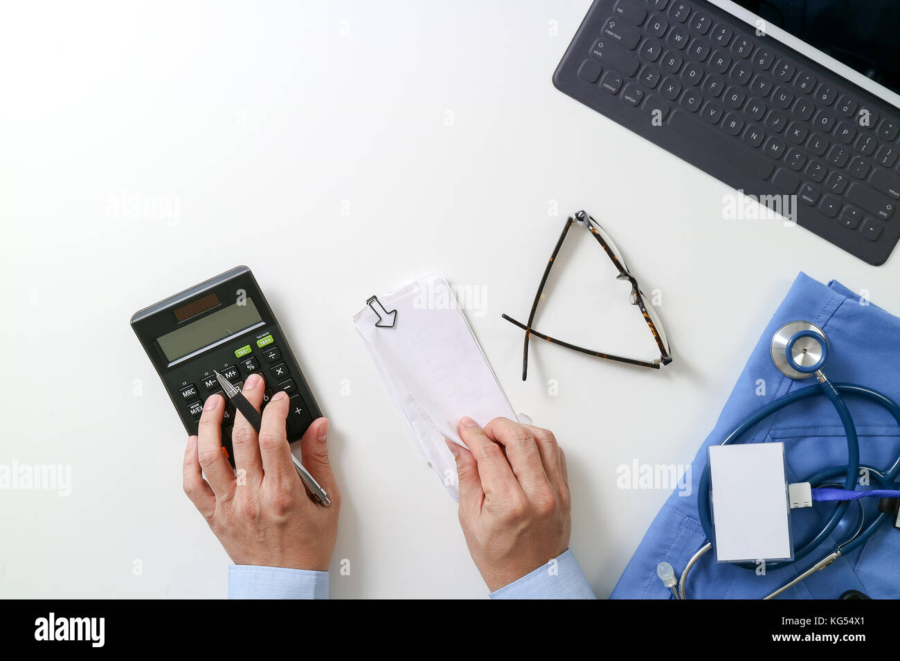 top view of Healthcare costs and fees concept.Hand of smart doctor used ...