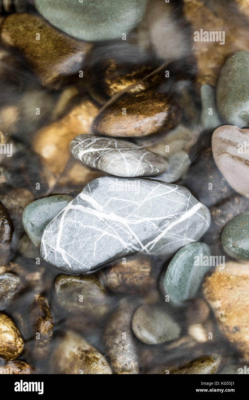 Patterned rocks in stream Stock Photo - Alamy