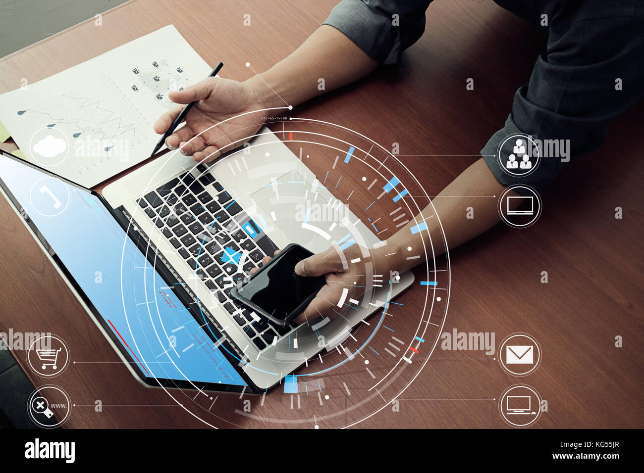 Hands of businessman using mobile phone in modern office with laptop ...