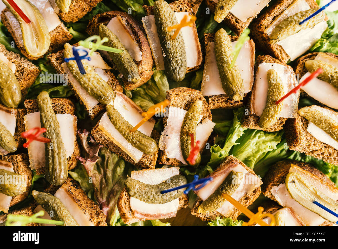 Buffet table with sandwiches of rye bread, lard and pickled cucumbers ...