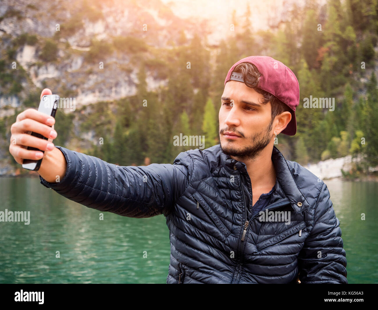 Young handsome man taking selfie with smartphone at lake in forest Stock Photo - Alamy