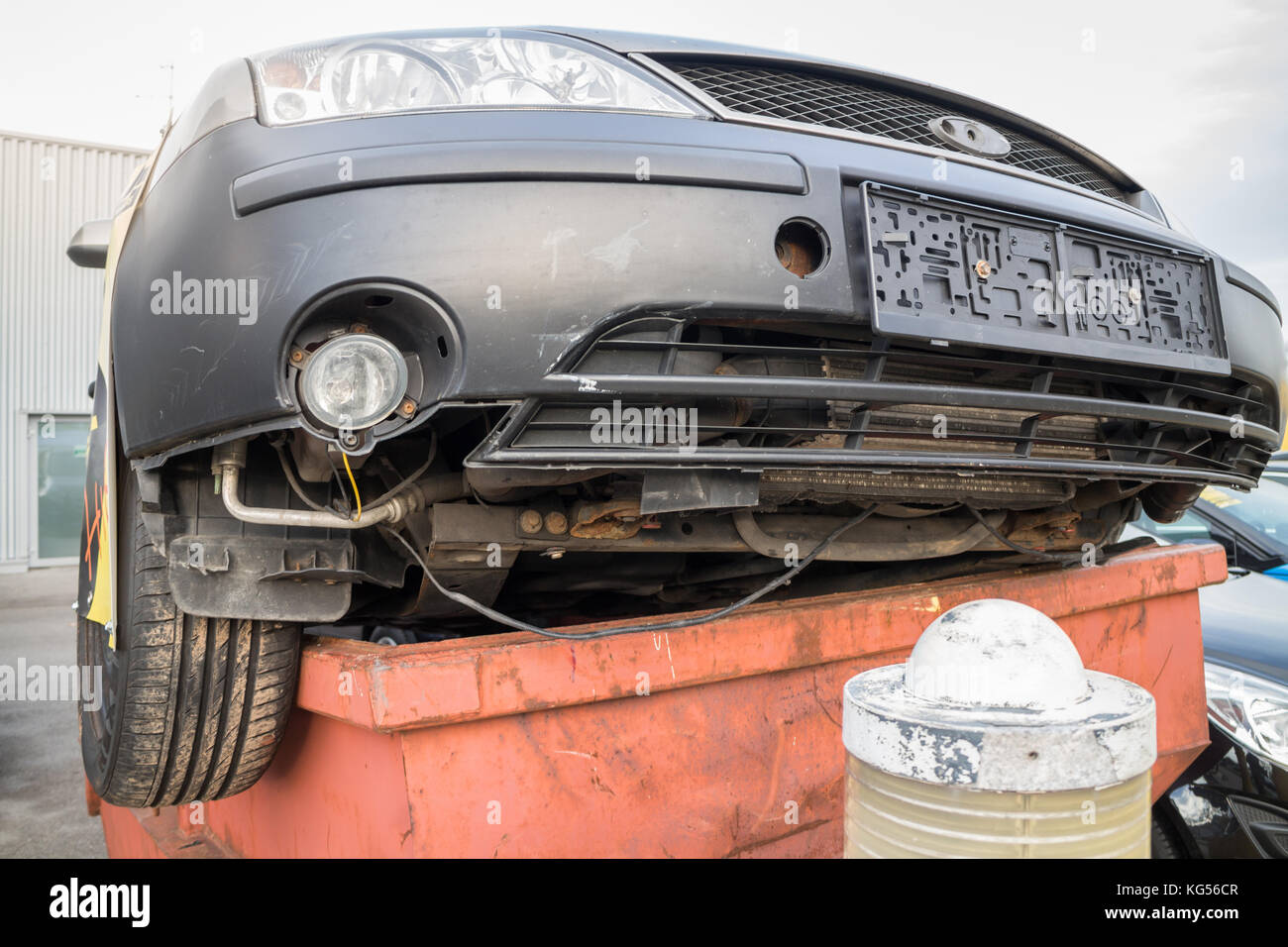 Old Broken Car placed in trash container Stock Photo - Alamy