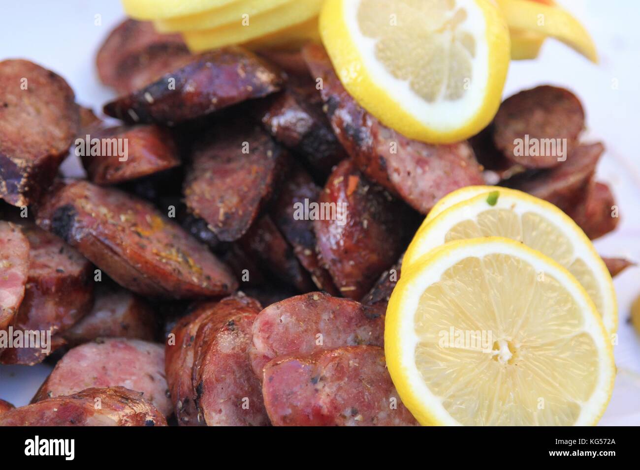 Cooked chorizo appetizers with lemon slices Stock Photo - Alamy