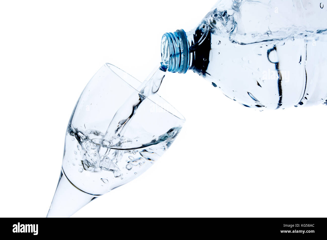 Filling glass with water from plastic bottle Stock Photo - Alamy
