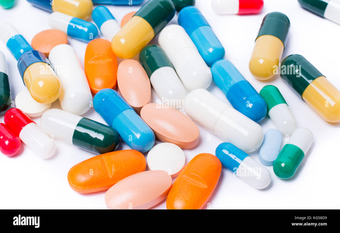 colored pills and capsule on white background Stock Photo - Alamy