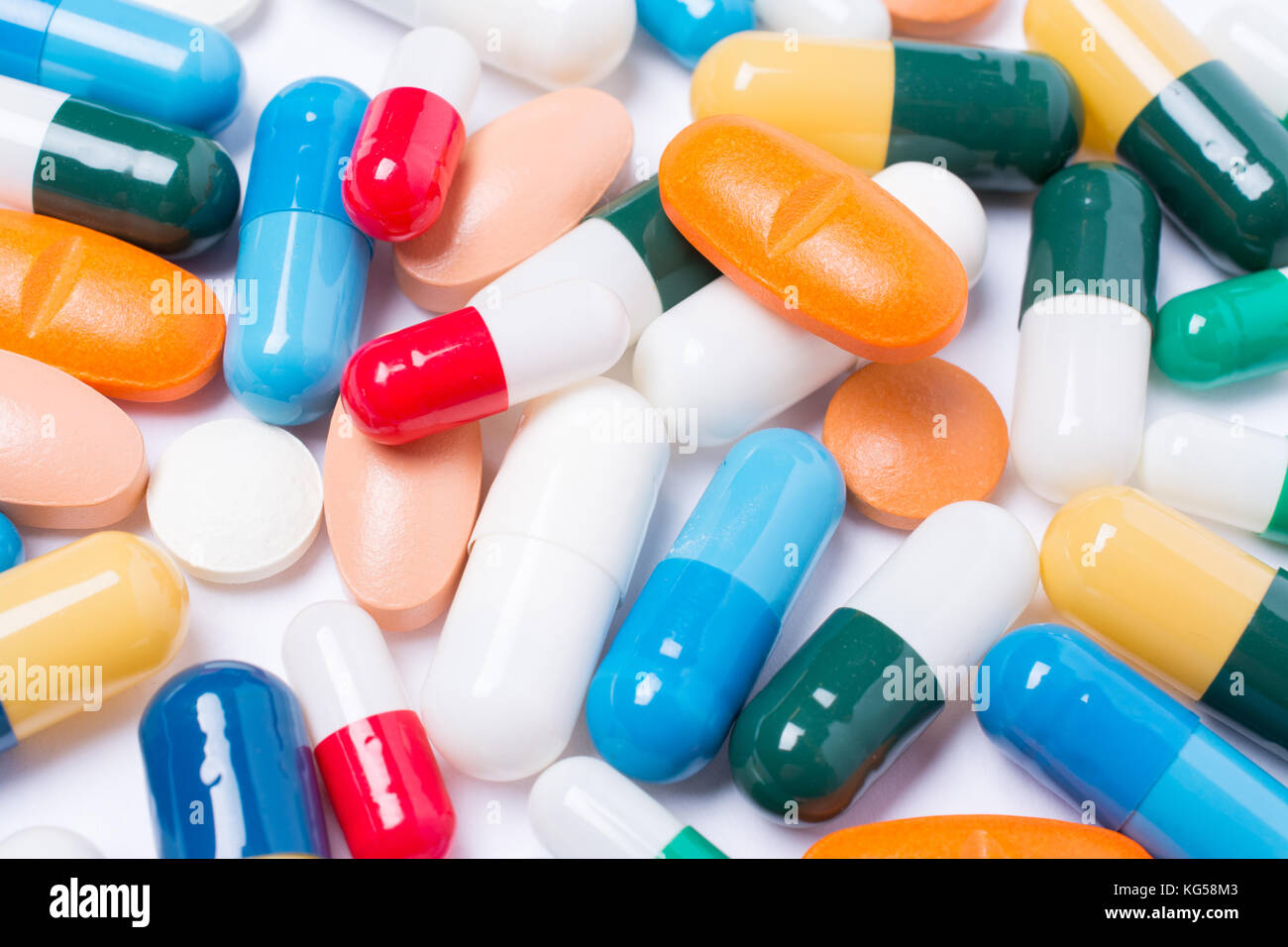 Pharmaceutical medicament, with colored pills and capsule on white ...