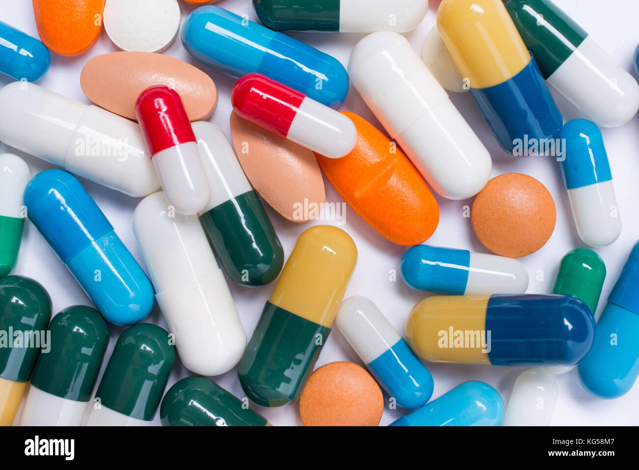 Pharmaceutical medicament, with colored pills and capsule on white ...