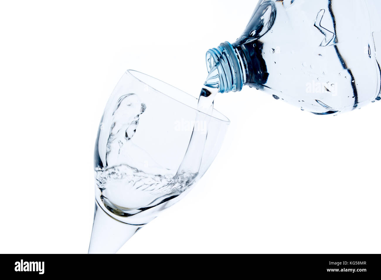 Filling glass with water from plastic bottle Stock Photo - Alamy