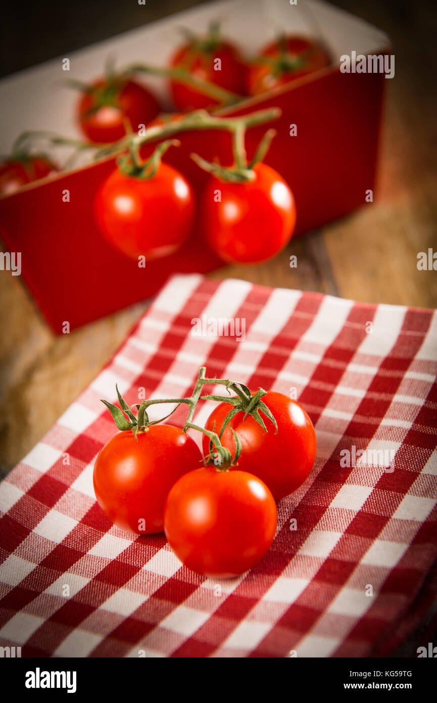 Fresh cherry tomatoes on travel and wooden background, France Stock ...