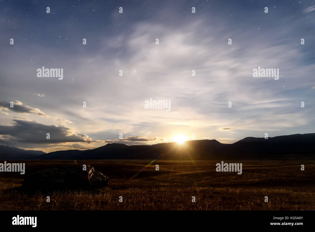 Beautiful night landscape with a big stone in the steppe, moonrise ...