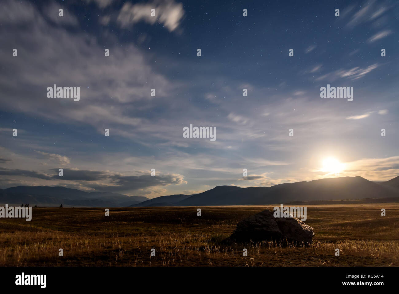 Beautiful night landscape with a big stone in the steppe, moonrise ...