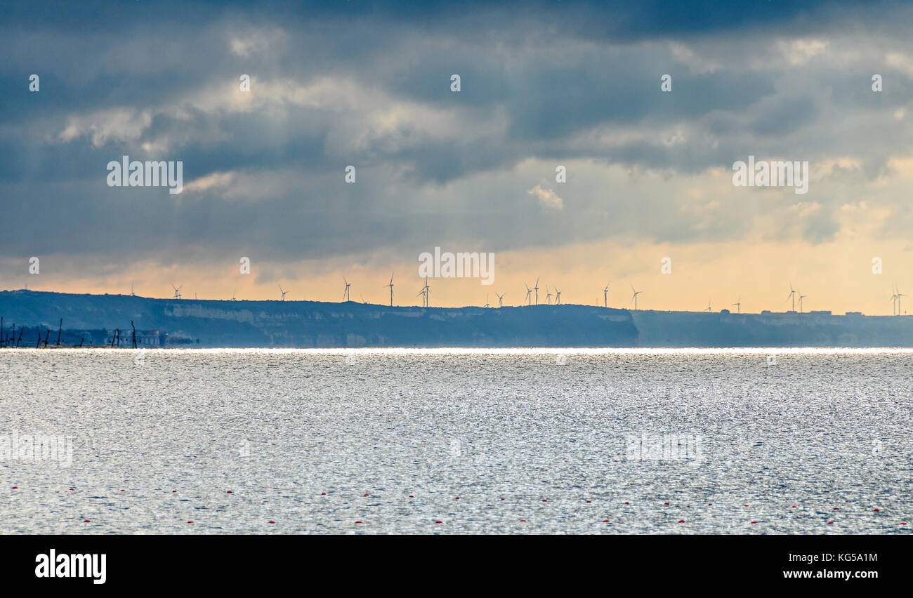 Eolian field and wind turbines farm, near Black Sea water, clouds blue ...