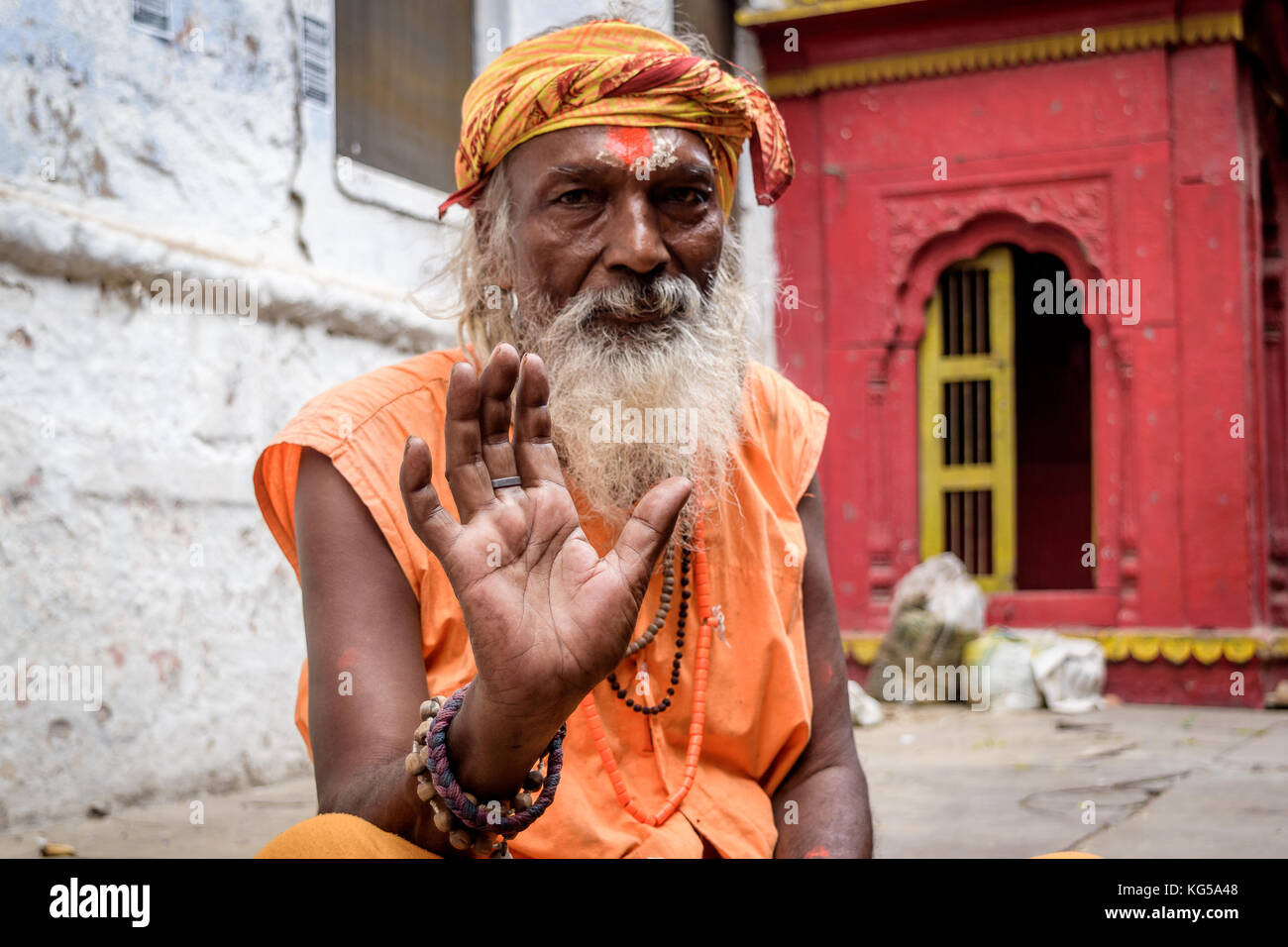 Portrait of a sadhu Baba posing with blessing hand in Varanasi, Utter ...