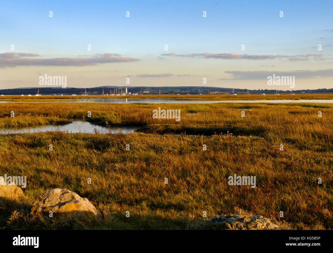 View of Hurst Castle and Lighthouse across the salt marshes in Keyhaven ...