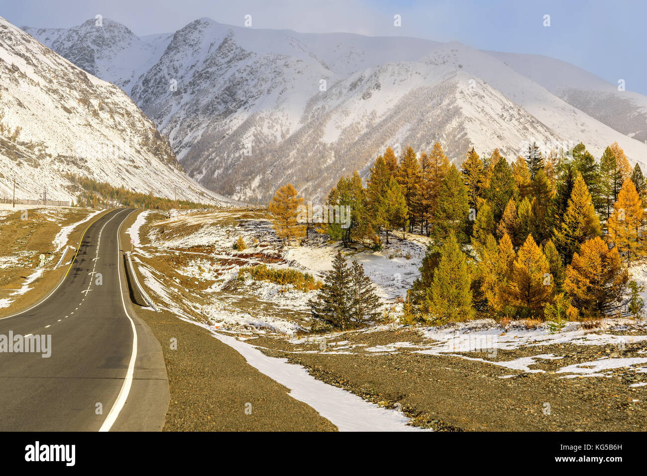 Scenic autumn view with an asphalt road in the mountains covered with ...