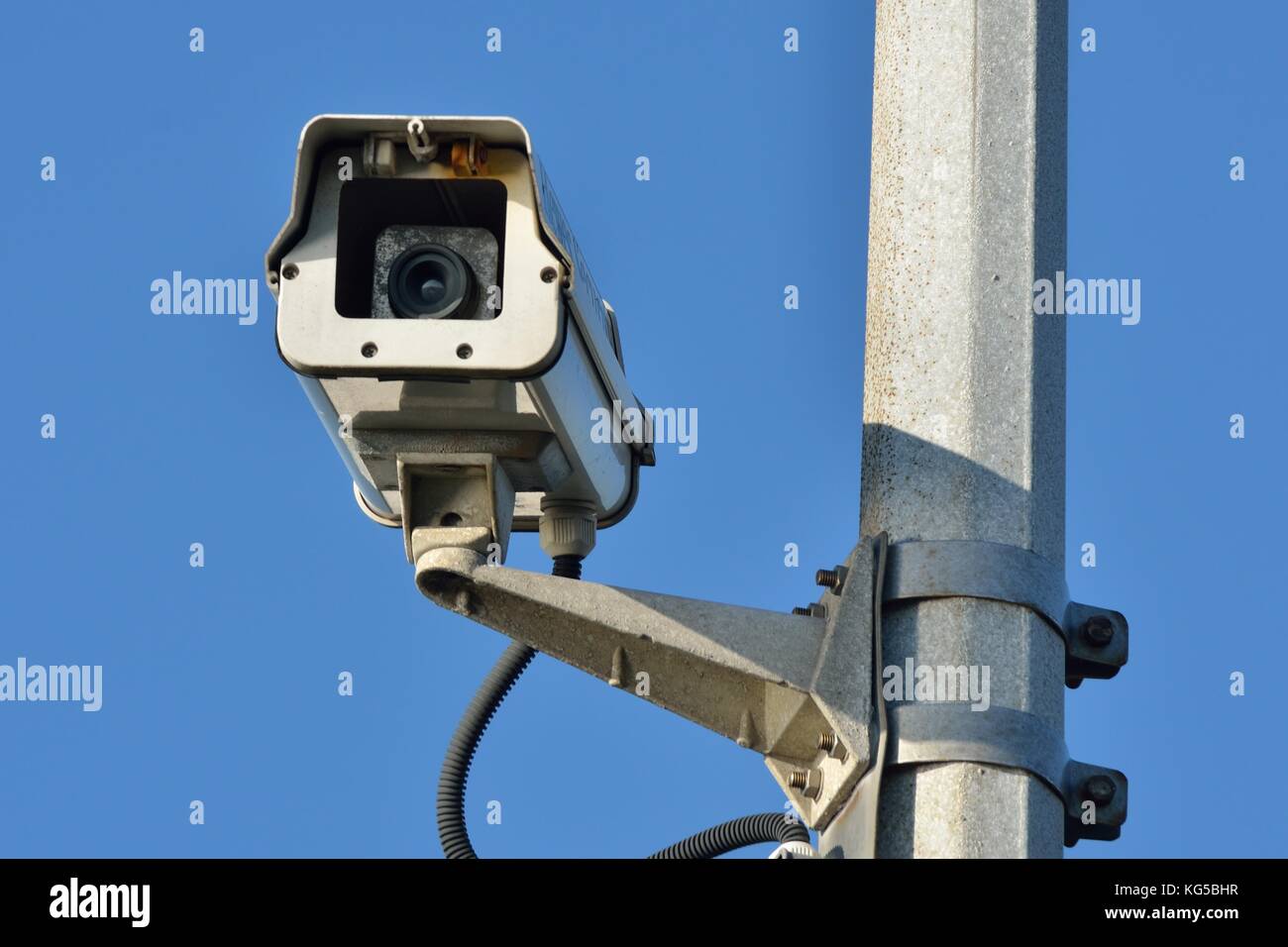 Security camera on post Stock Photo - Alamy