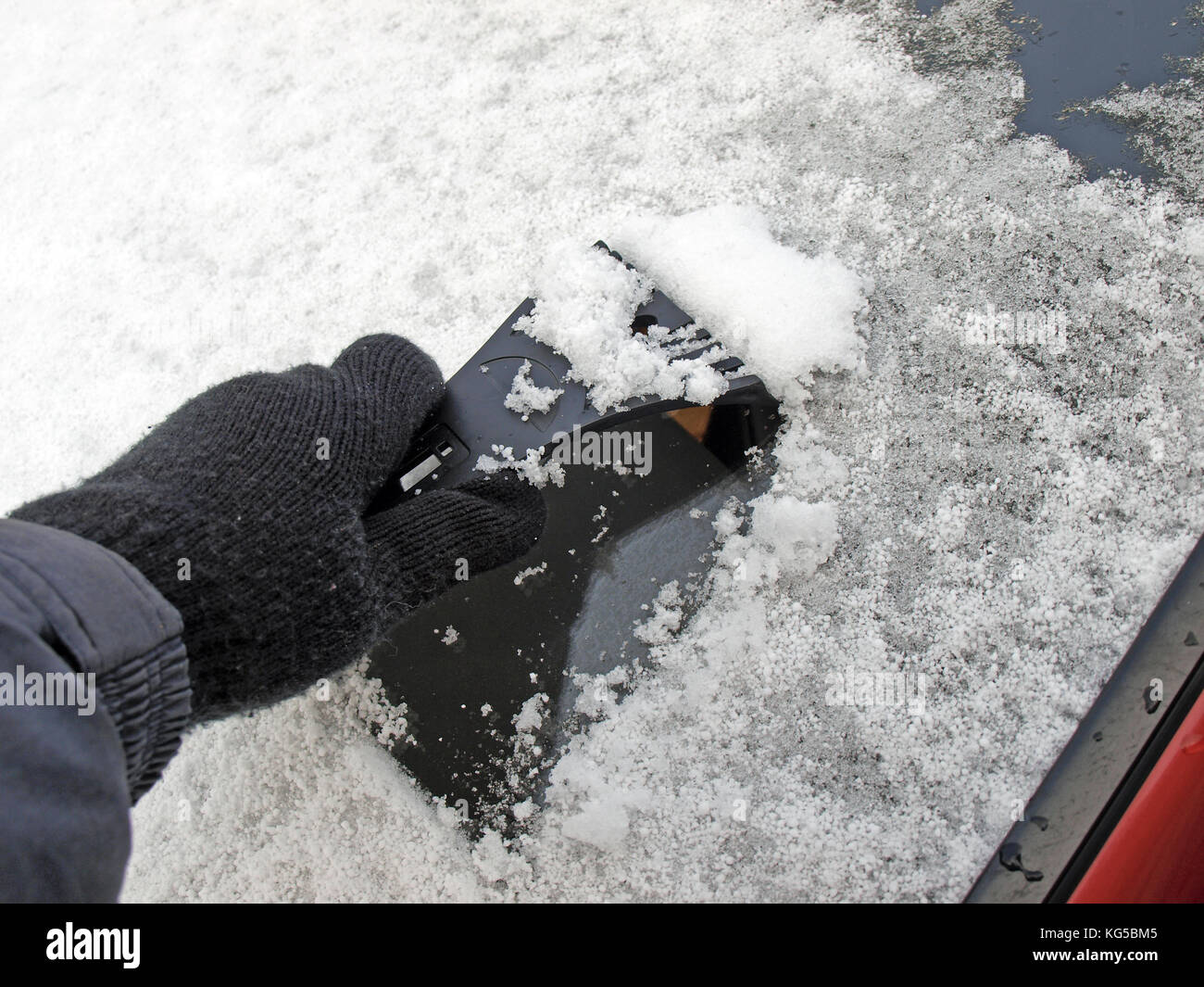Hand with plastic cleaner cleaning snow from car window Stock Photo - Alamy