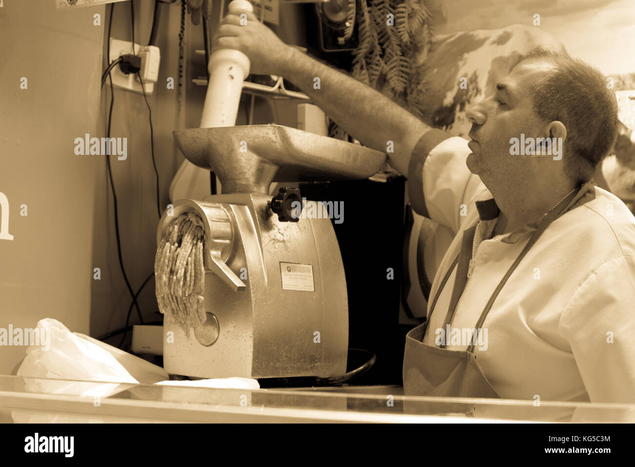 butcher chopping meat with a machine Stock Photo - Alamy