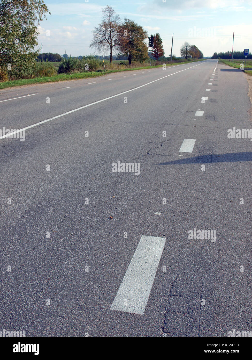 Asphalt road with marker lines in rural district Stock Photo - Alamy
