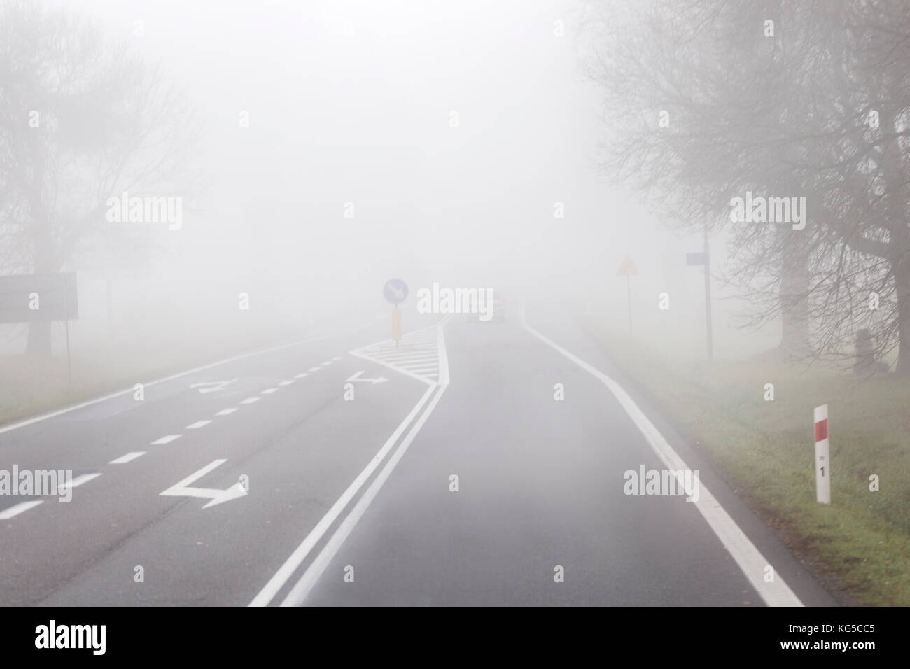 Car driving the Fog Road background Stock Photo - Alamy