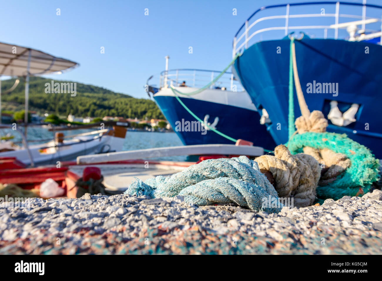 Docked two large fishing ships tied with rope to a moor at the local ...