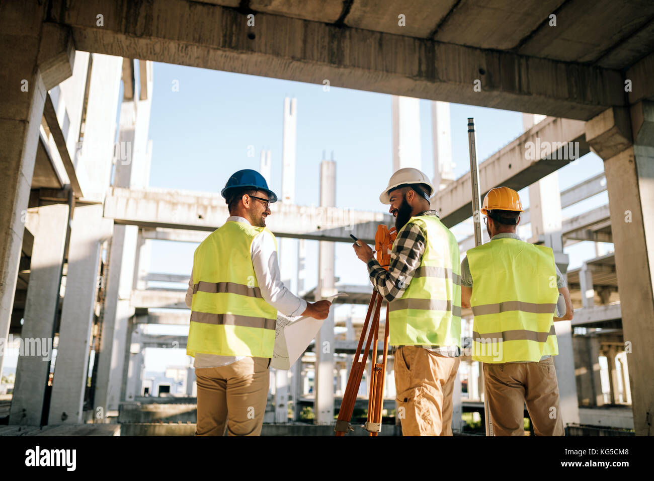 Team of construction engineers working on building site Stock Photo - Alamy