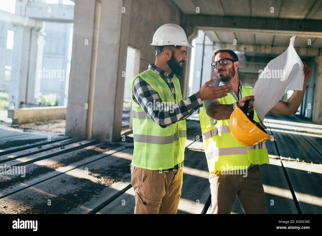 Portrait of construction engineers working on building site Stock Photo ...