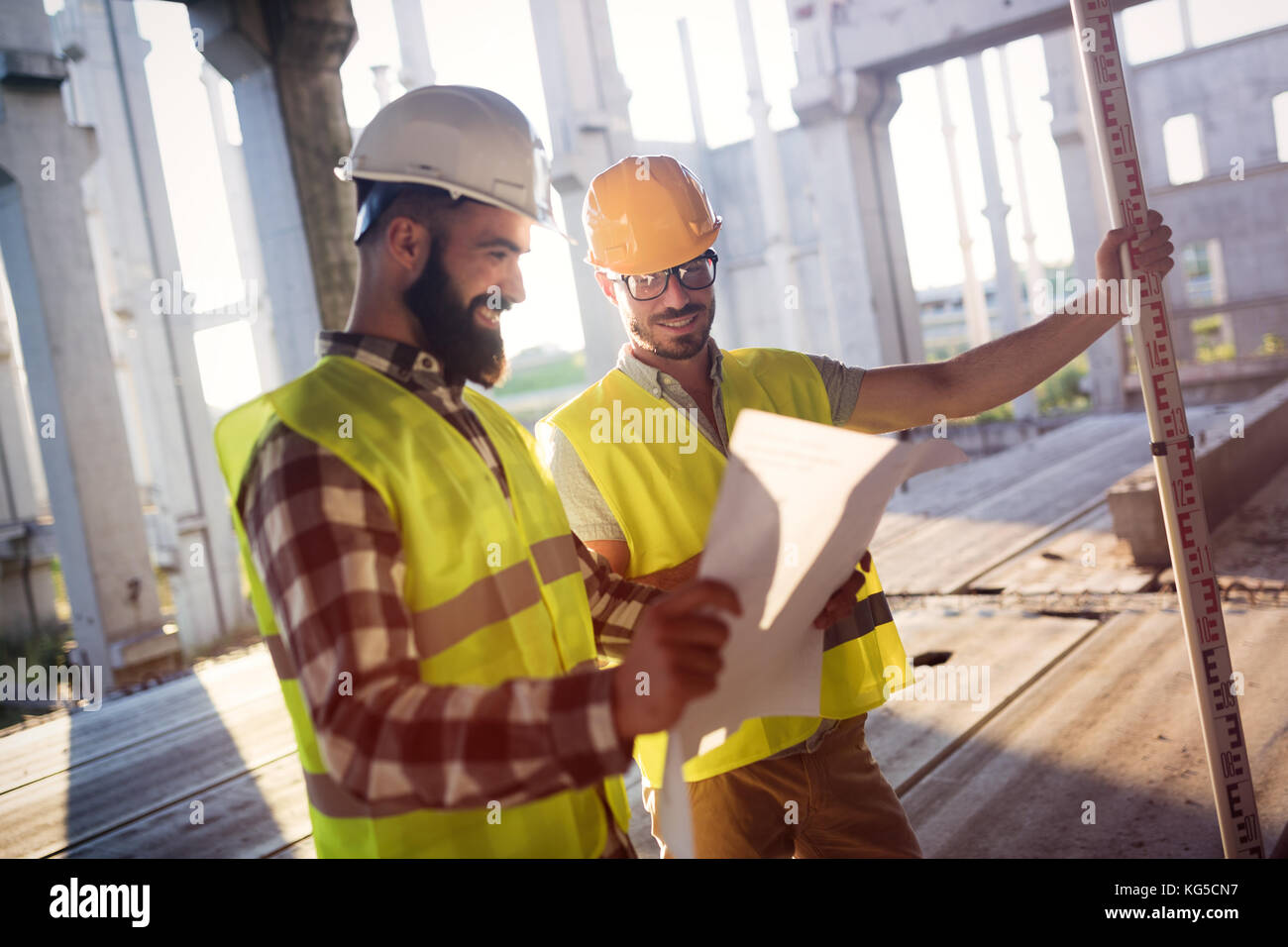 Portrait of construction engineers working on building site Stock Photo ...