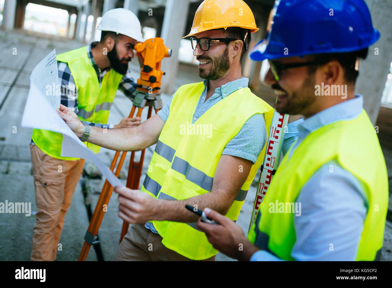 Portrait of construction engineers working on building site Stock Photo ...